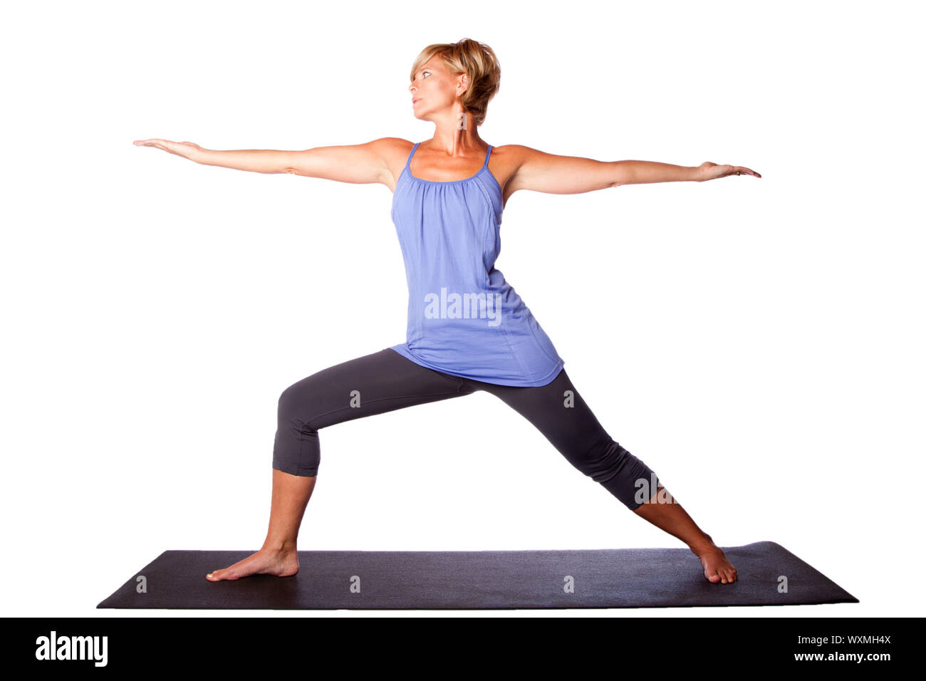 Warrior Two Virabhadrasana yoga pose extending arms by beautiful ...