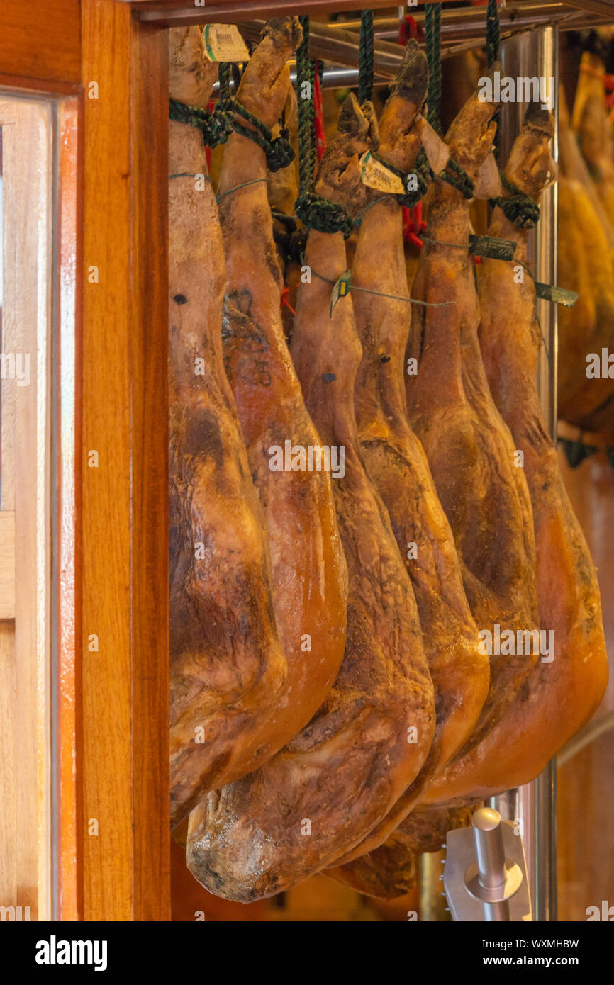 Jamon famous Spanish cuisine cured pork leg hang in store Stock Photo ...