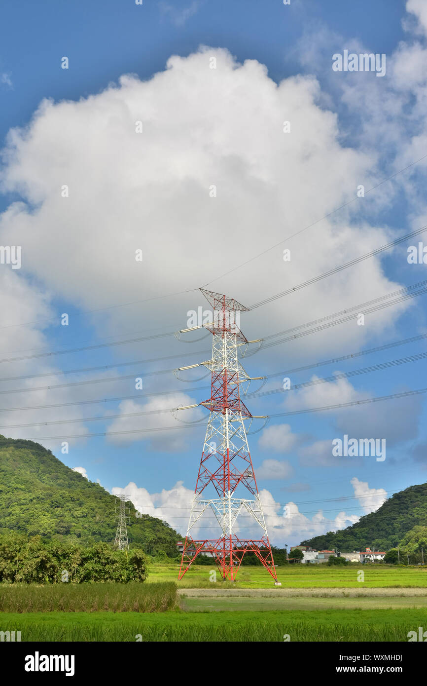 Electronic tower on the meadow under cloudy blue sky Stock Photo - Alamy