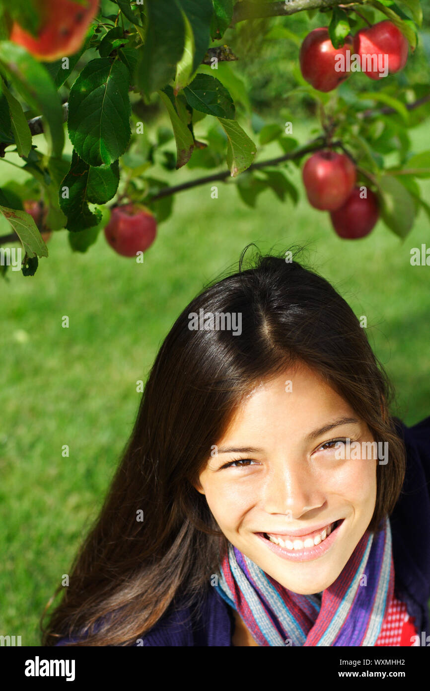 Autumn woman under apple tree Stock Photo - Alamy