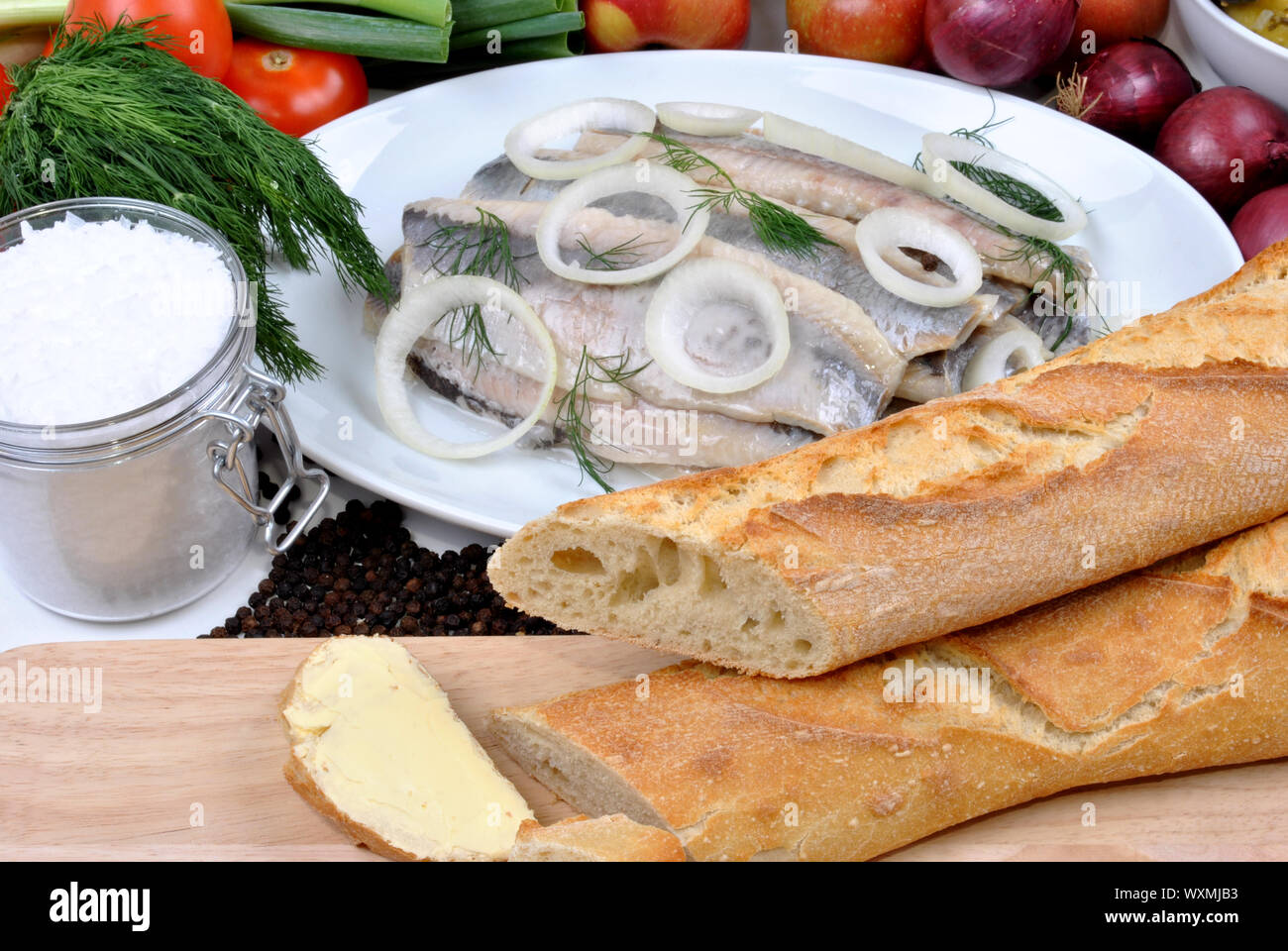 some fresh organic herring on a white plate Stock Photo - Alamy