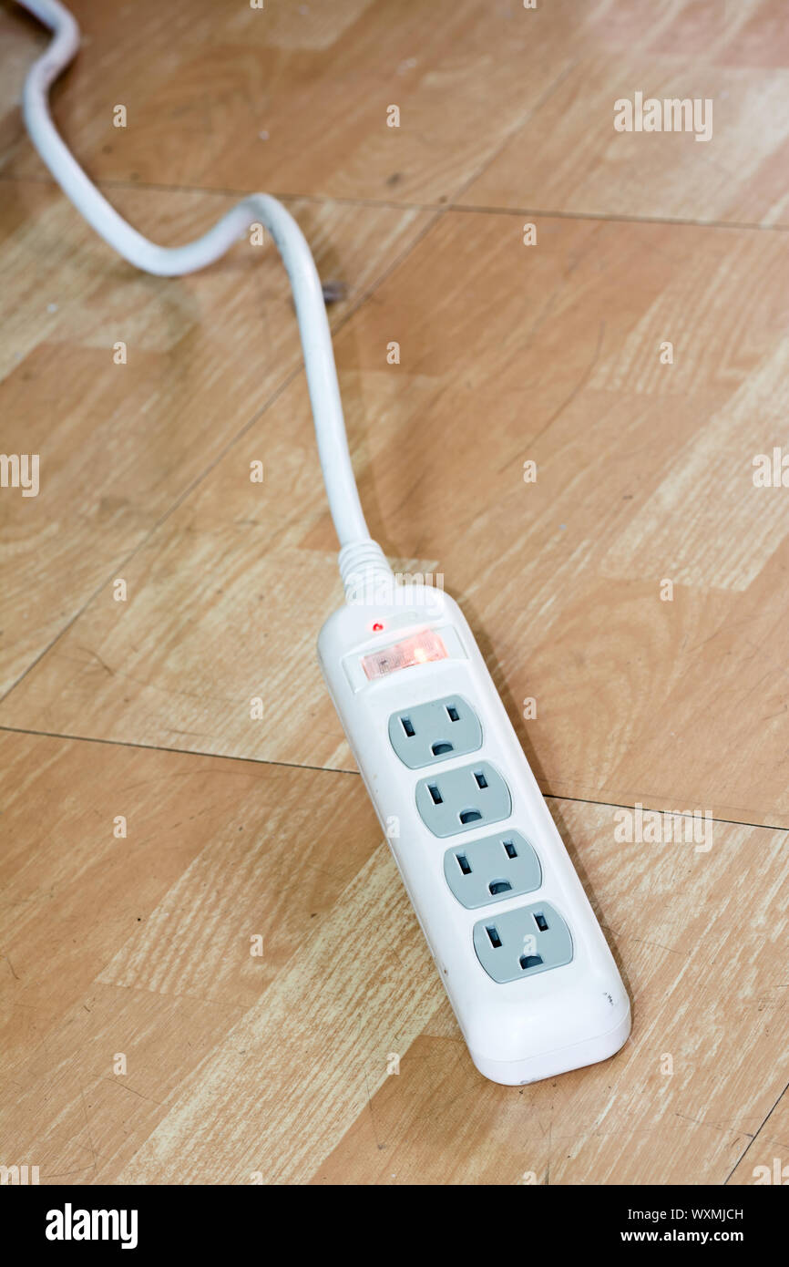 White power strip or extension block laying on the floor Stock Photo ...