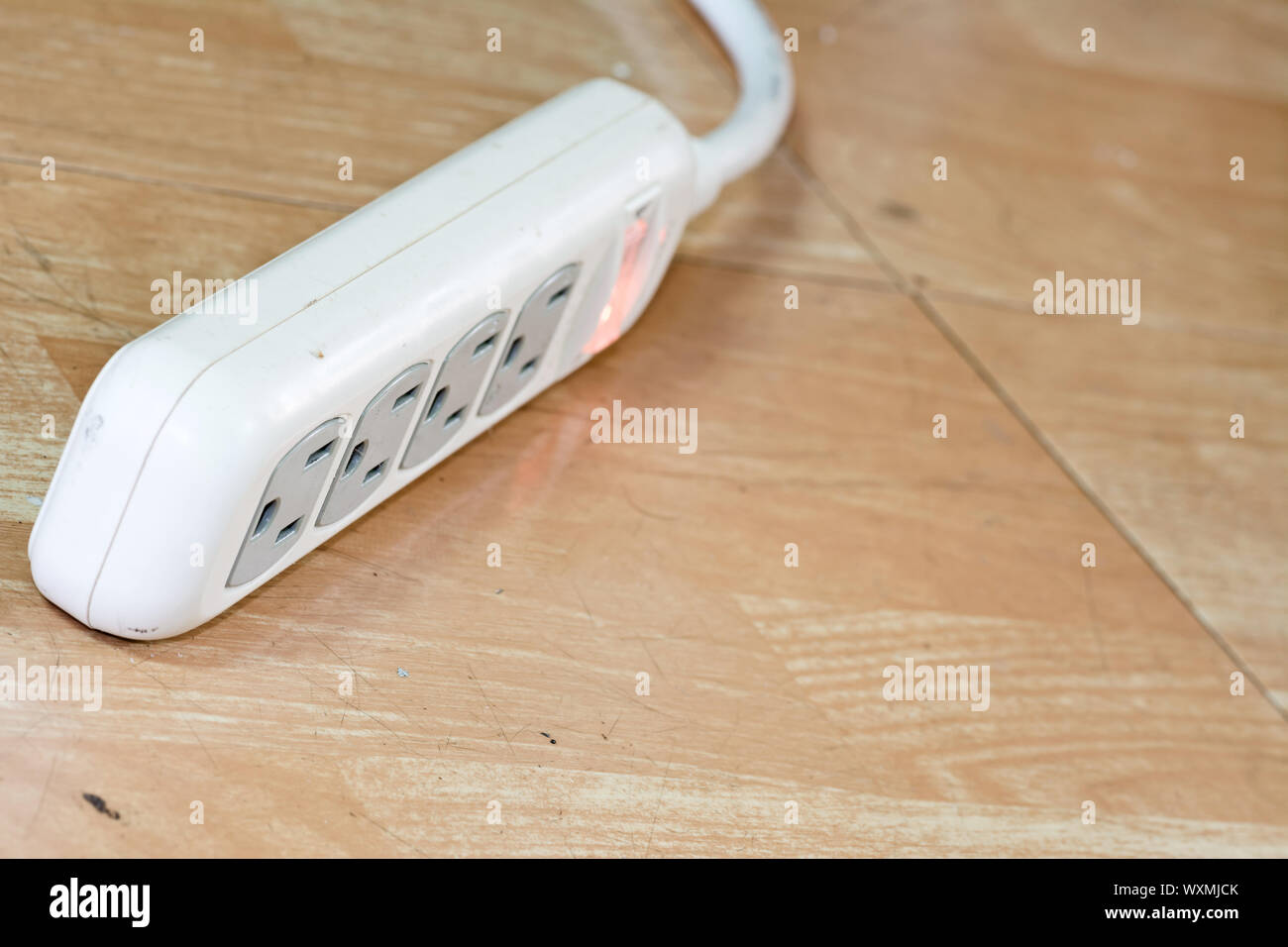 White power strip or extension block laying on the floor Stock Photo ...