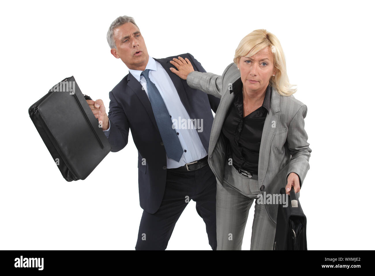Two businesspeople pushing past each other Stock Photo - Alamy
