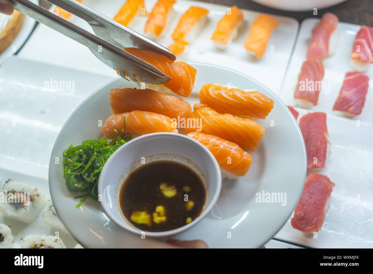 Human hands holding plate sushi hi-res stock photography and images - Alamy