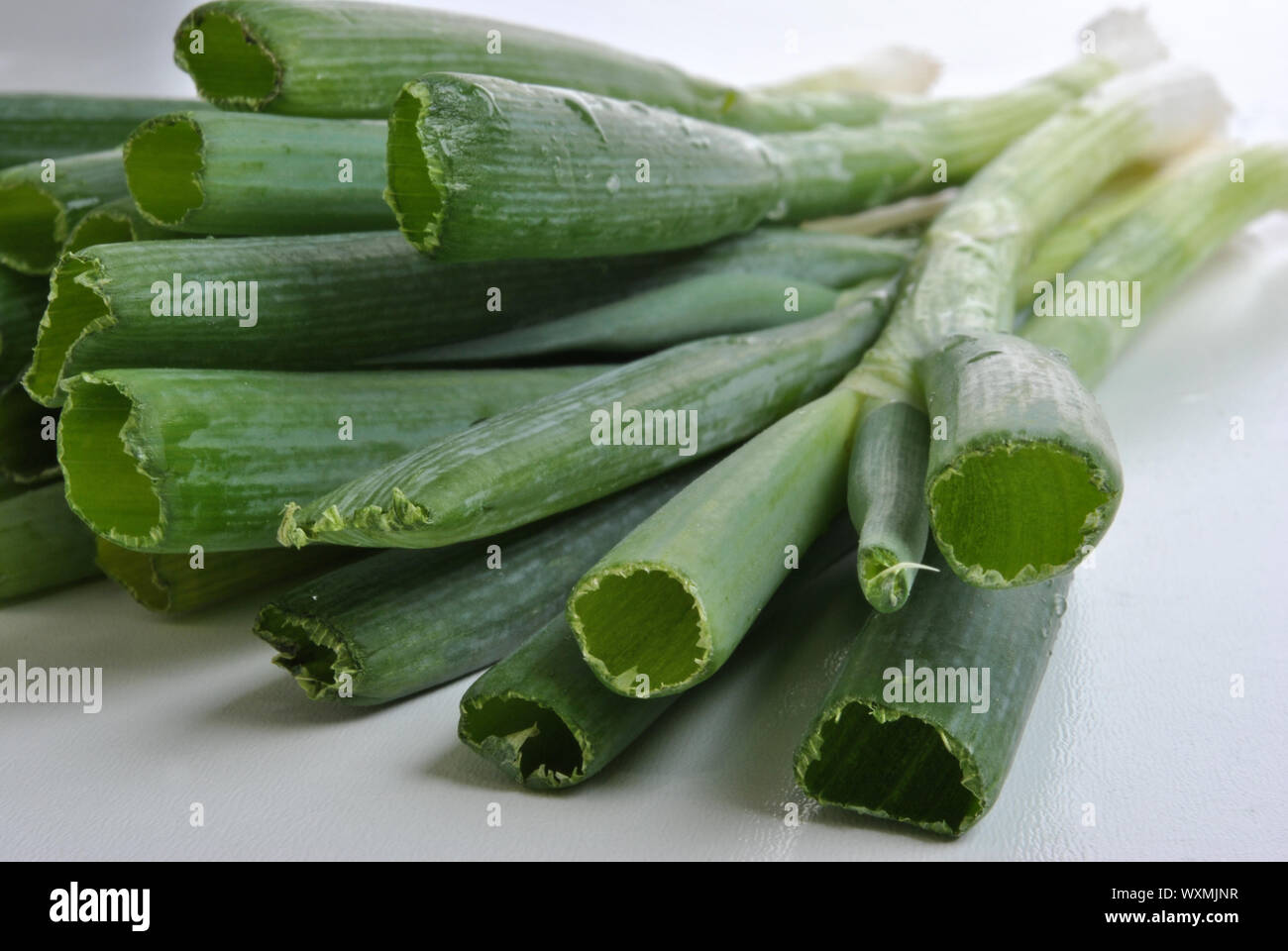organic spring onion on a bright background Stock Photo - Alamy