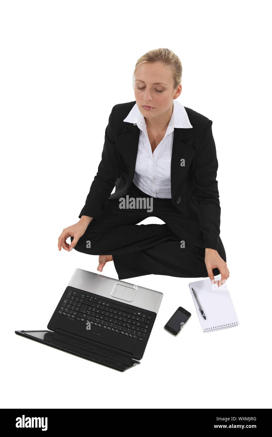 Businesswoman sat in yoga position Stock Photo - Alamy