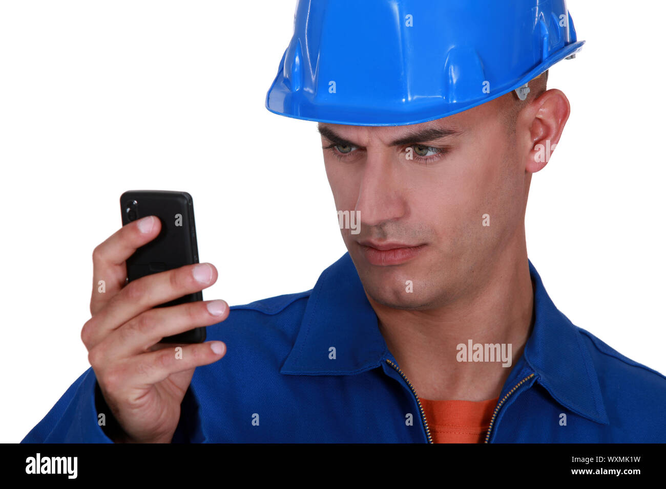 portrait of young blue collar reading sms against white background ...
