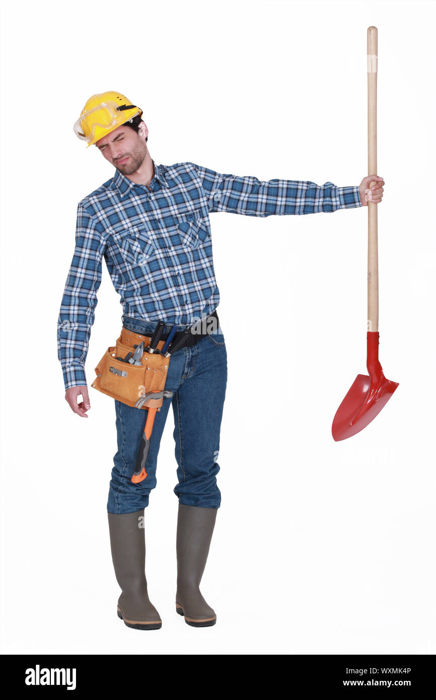Disgusted man holding shovel Stock Photo - Alamy