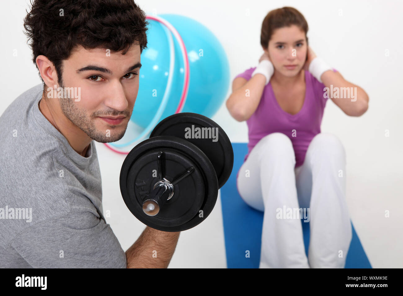 Couple exercising at the gym together Stock Photo - Alamy