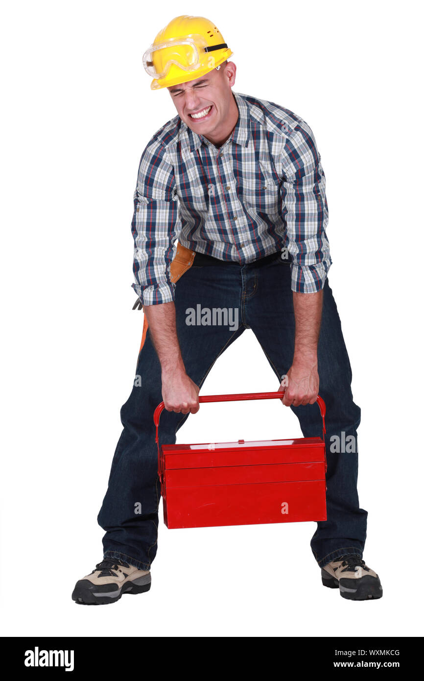Craftsman lifting heavy tool box Stock Photo - Alamy