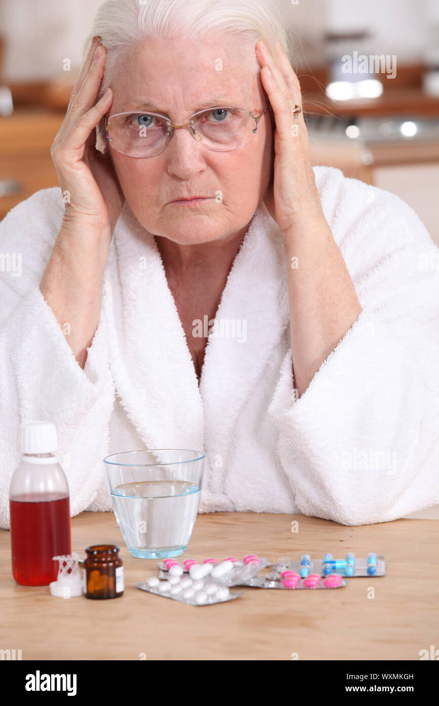 Bitter woman in front of her medication Stock Photo - Alamy