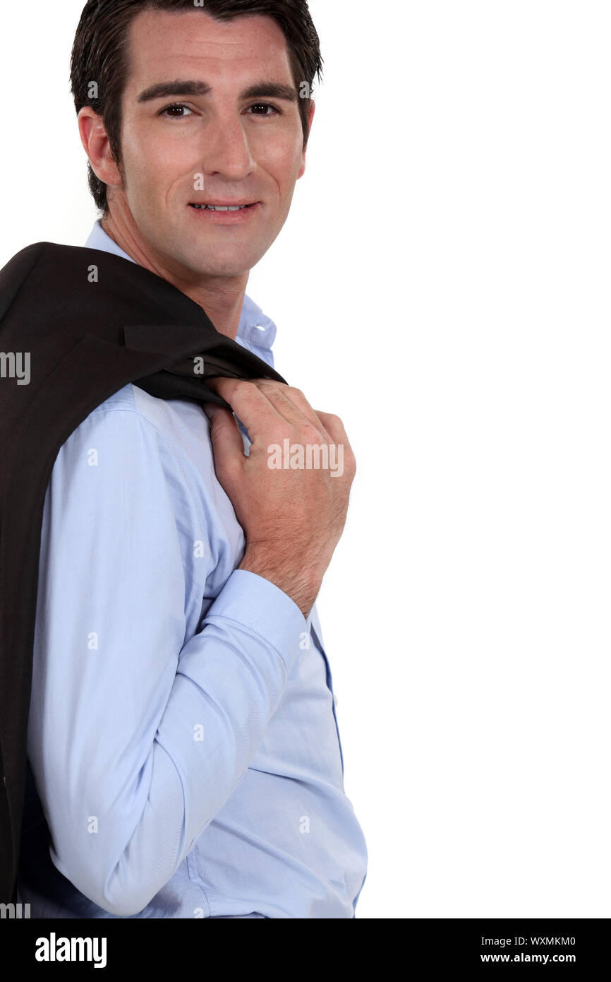Successful businessman posing with jacket over shoulder Stock Photo - Alamy