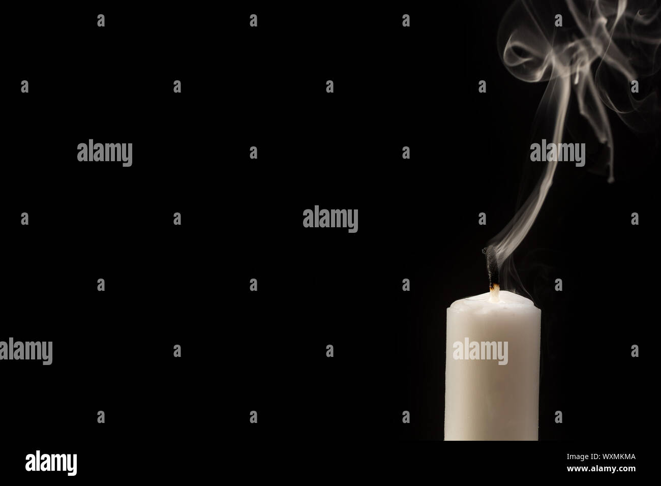 Candle with extinguished flame in front of black background Stock Photo ...