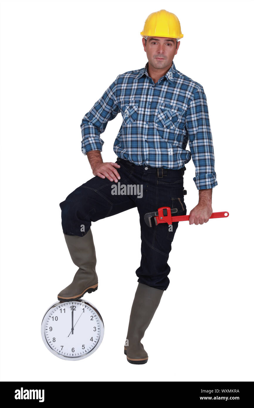 Construction worker with a clock Stock Photo - Alamy