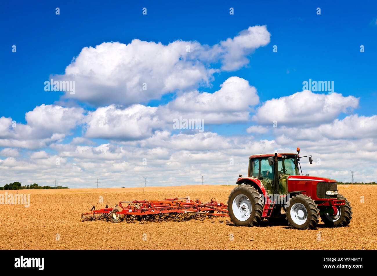 Small scale farming with tractor and plow in field Stock Photo - Alamy