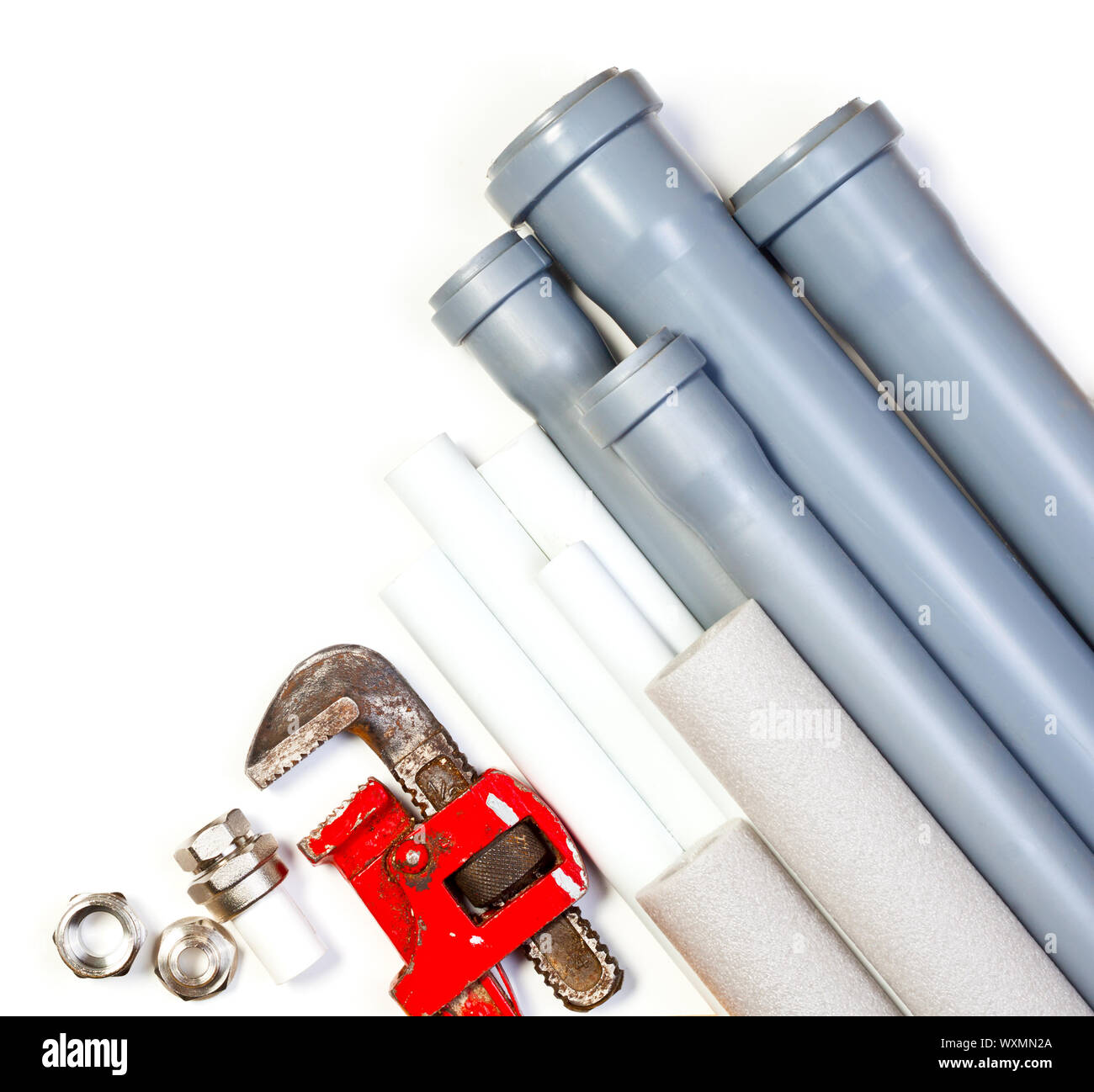 Hard used red plumbing tool pipes and fittings on white background ...