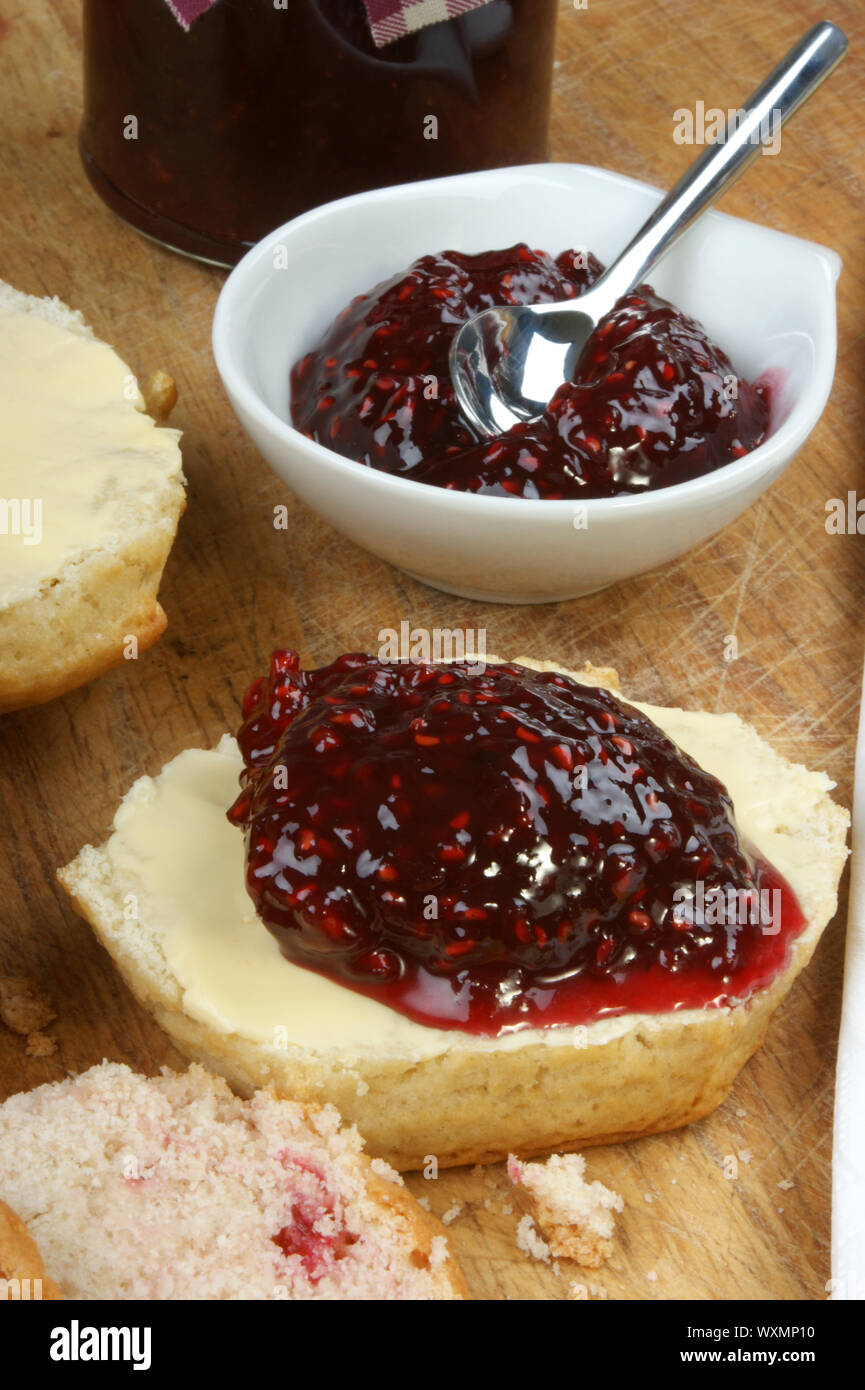scone with organic jam on a timber board Stock Photo - Alamy