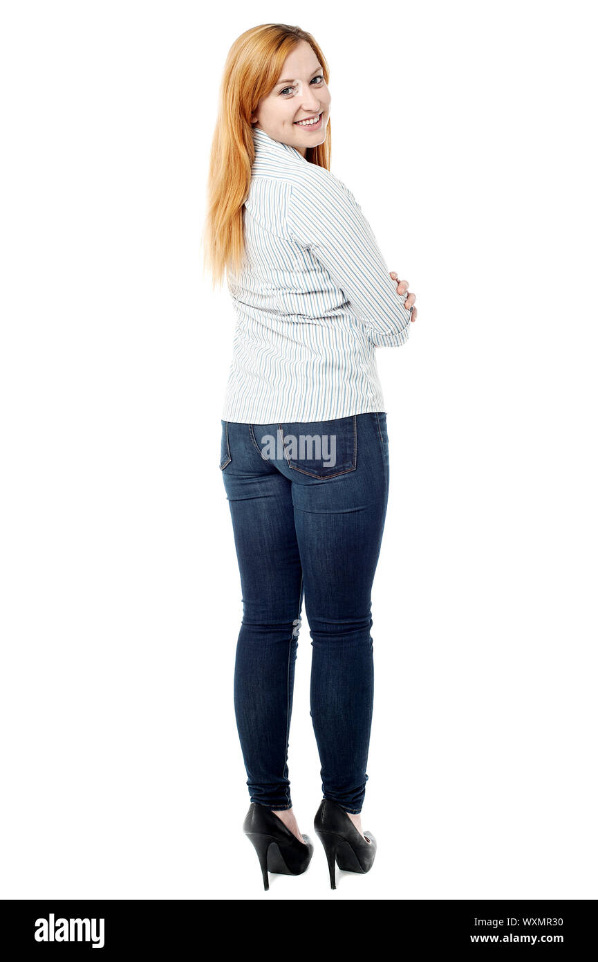 Full length image of a young woman looking back Stock Photo - Alamy