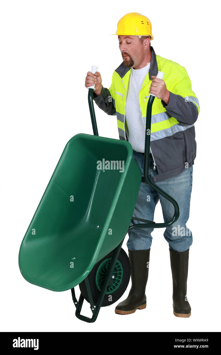 Man lifting a wheelbarrow Stock Photo - Alamy