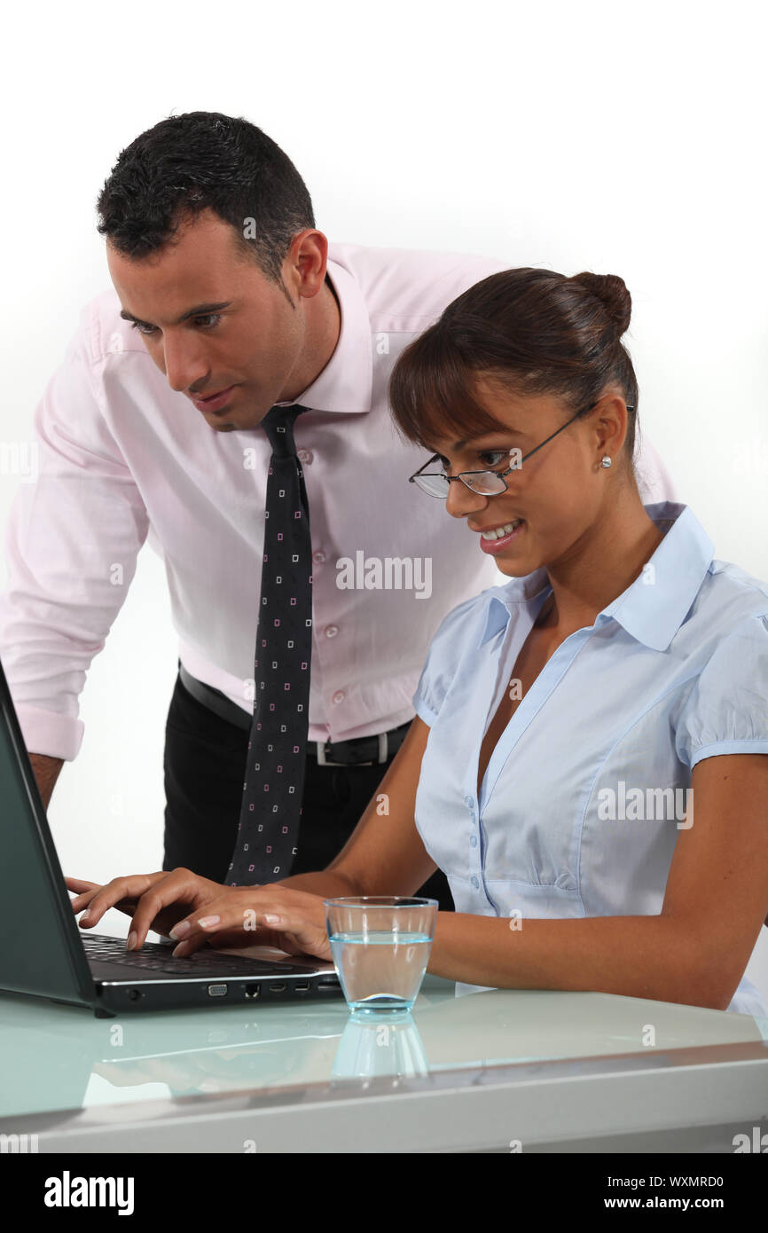 Man supervising his assistant's work Stock Photo - Alamy