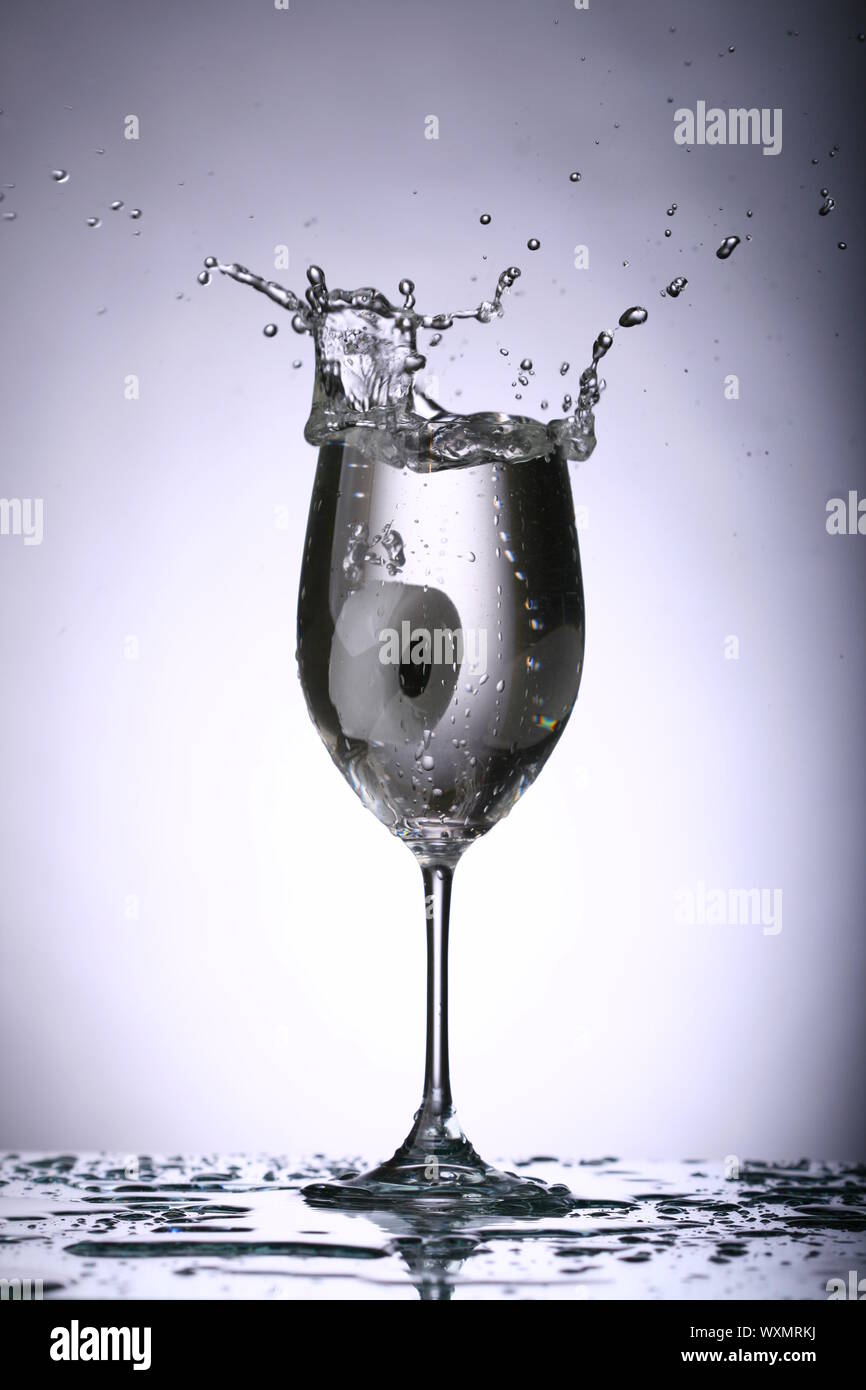 alcohol splash on gray background Stock Photo - Alamy