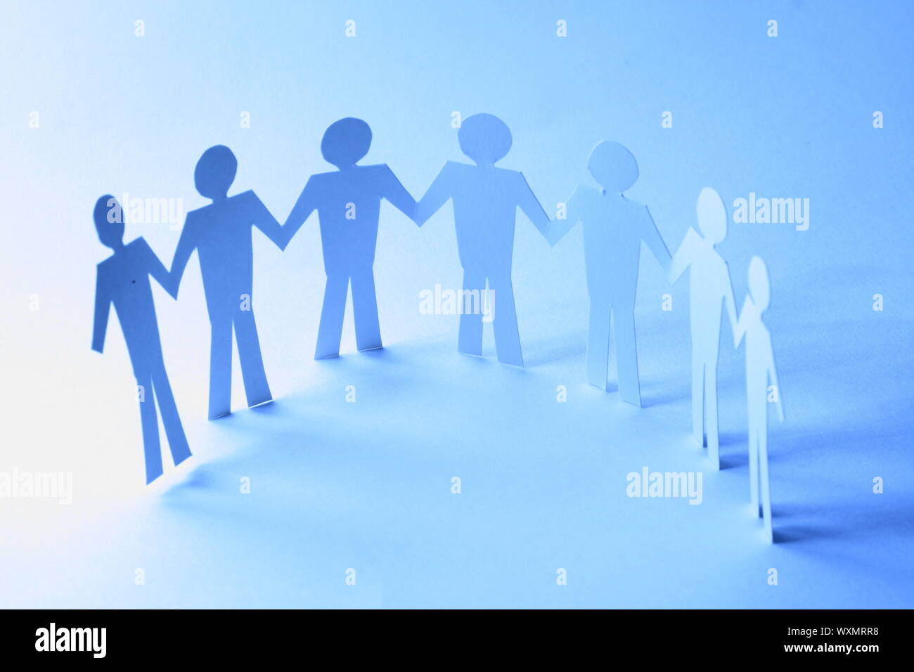 paper team linked together partnership concept Stock Photo - Alamy