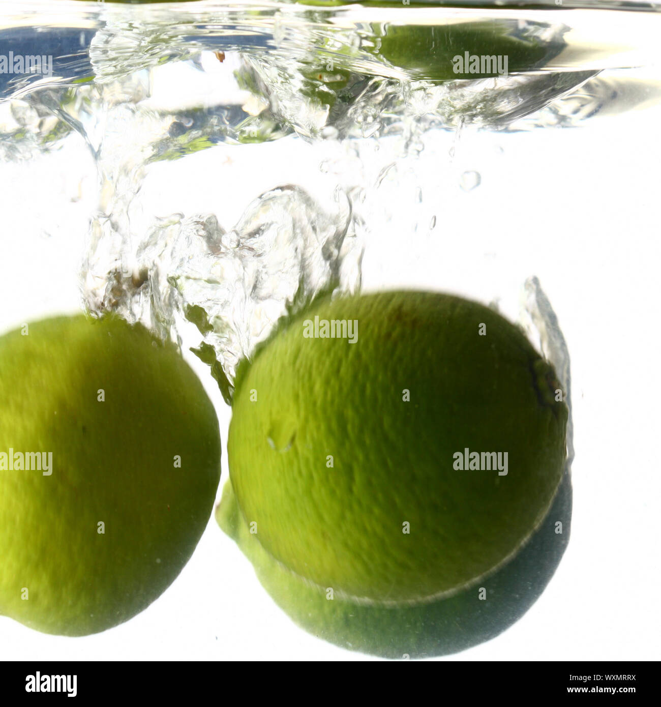 lime splash isolated on white background Stock Photo - Alamy
