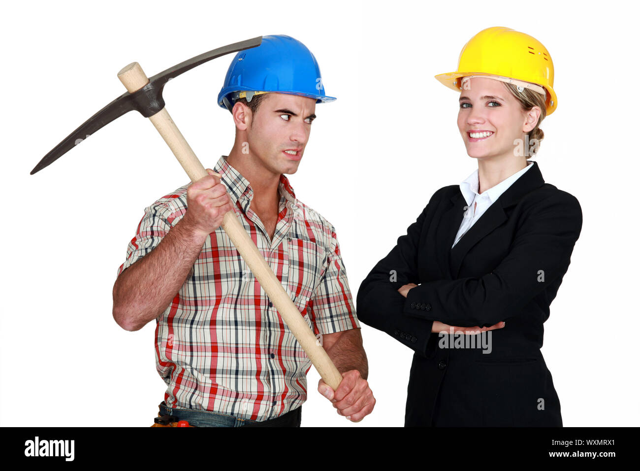 Builder aiming his pickaxe at a smiling architect Stock Photo - Alamy