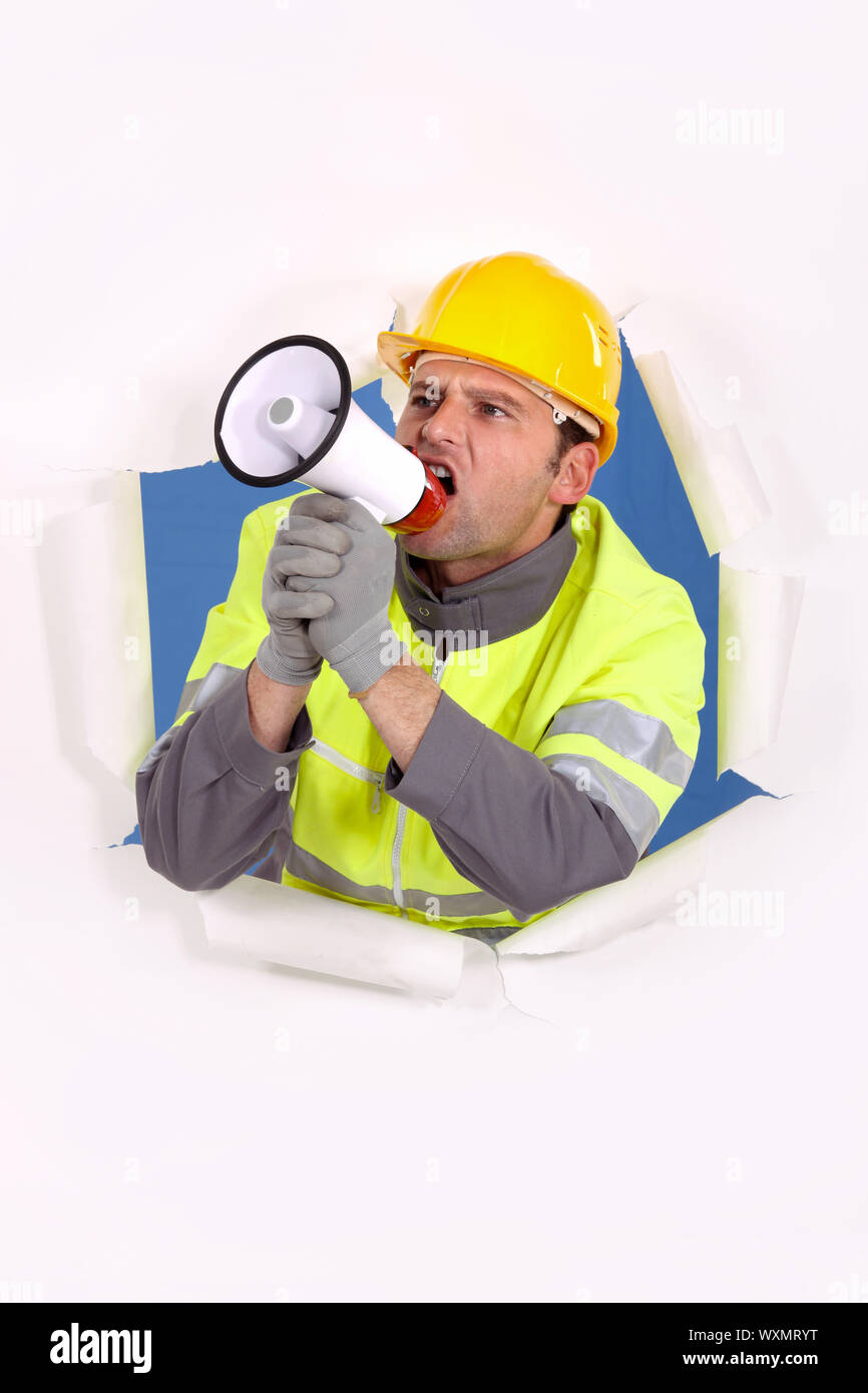 Builder shouting into megaphone Stock Photo - Alamy