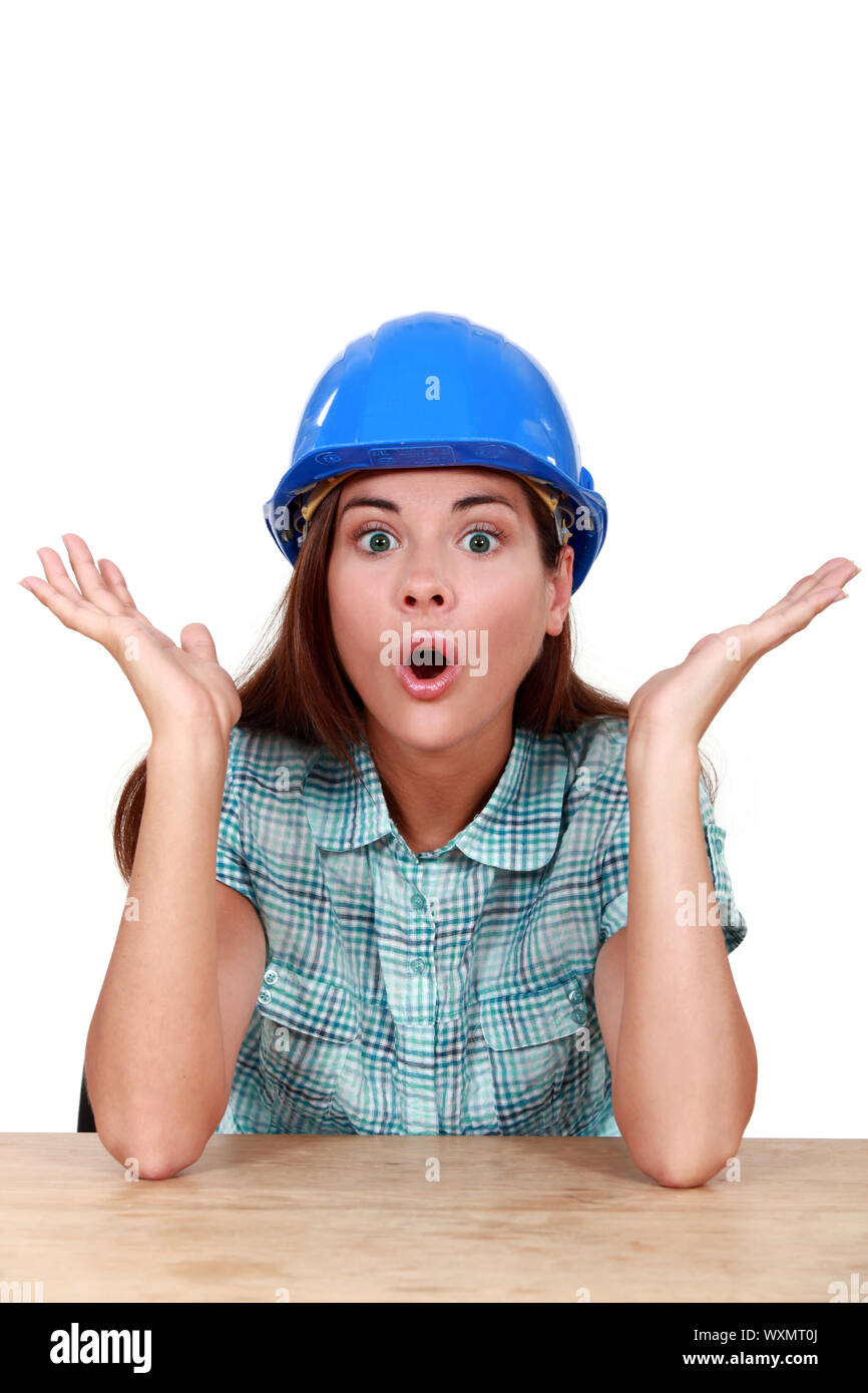 Surprised female construction worker Stock Photo - Alamy