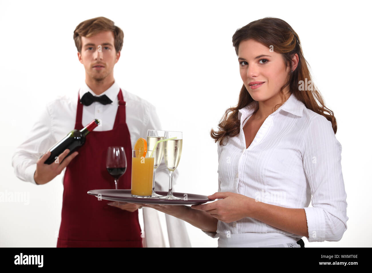 Wine waiter and waitress, studio shot Stock Photo - Alamy