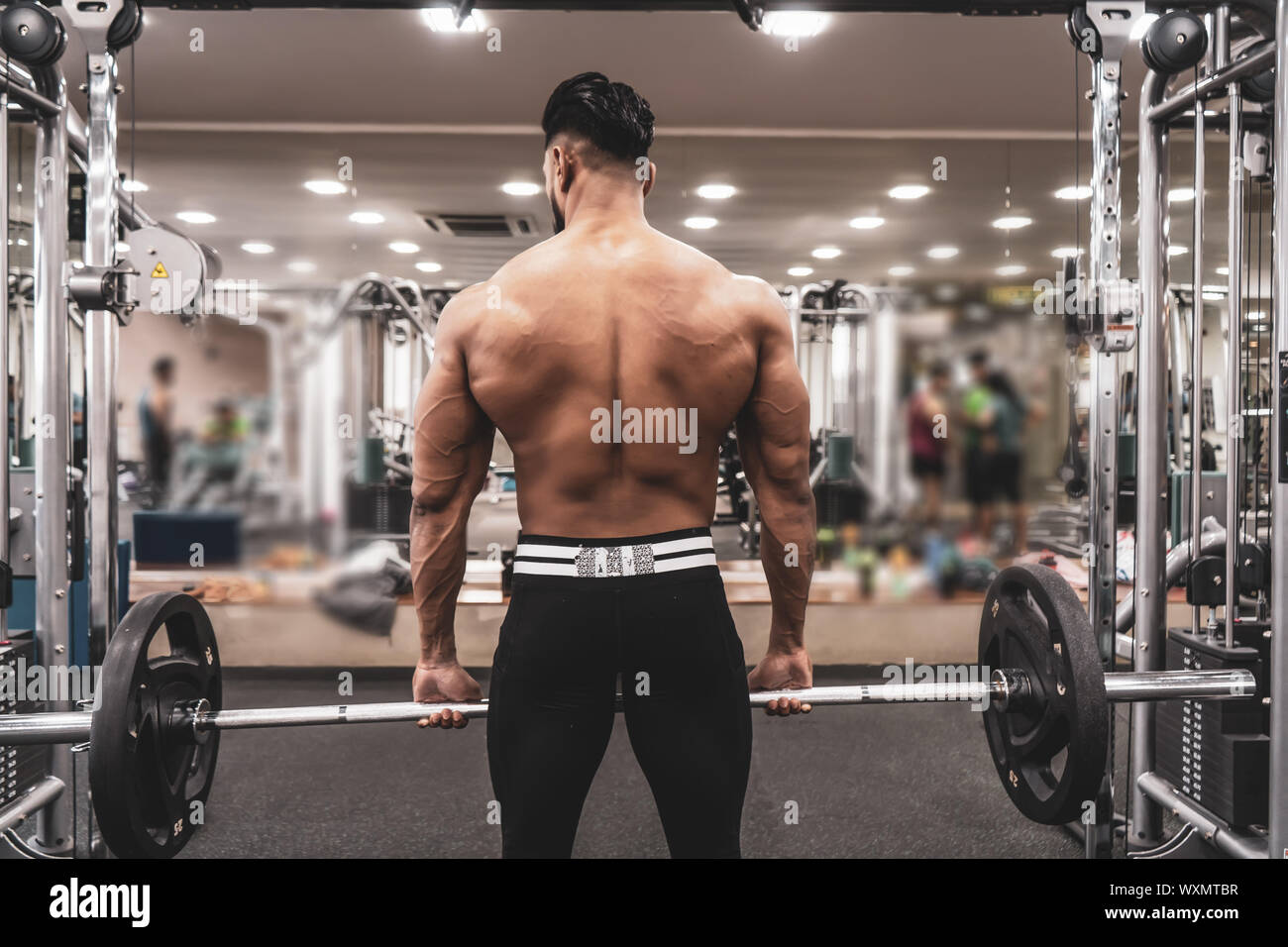 Muscular Man Doing Heavy Deadlift Exercise. Young athlete getting ready ...