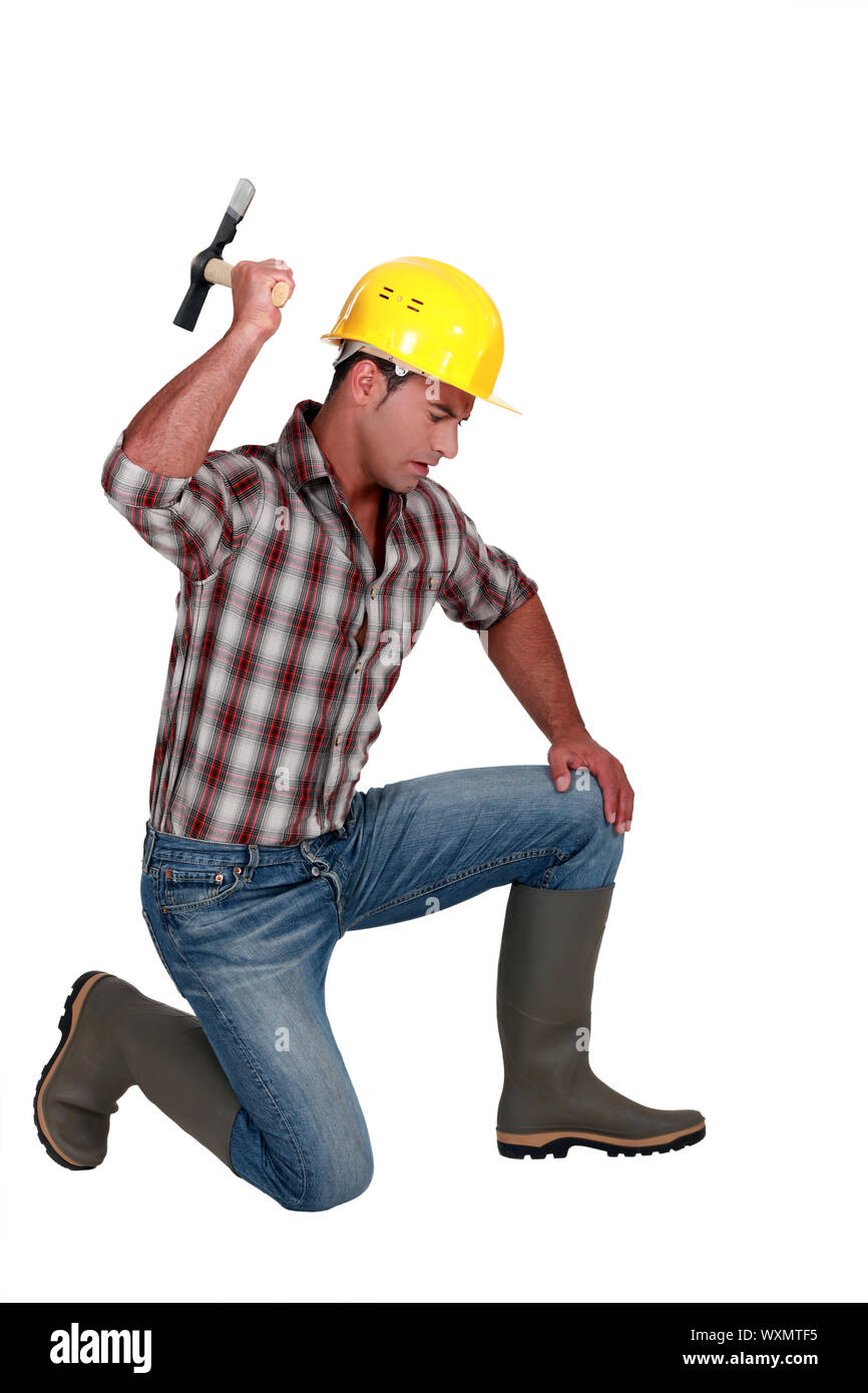 Construction worker with hammer Stock Photo - Alamy