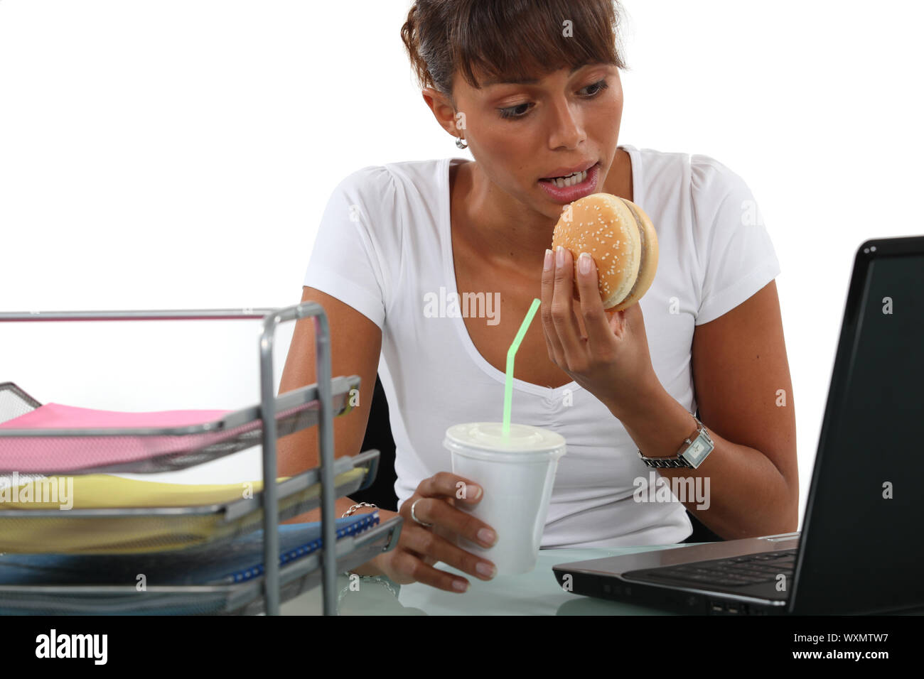 Office worker having a quick lunch in front of her computer Stock Photo ...