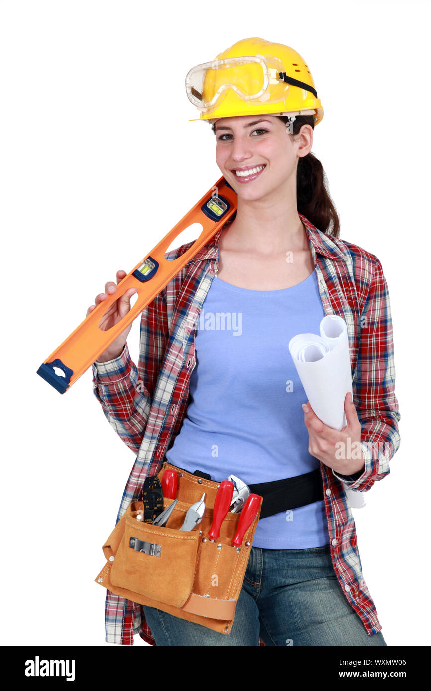 Female construction worker holding tools and a rolled-up plan Stock ...