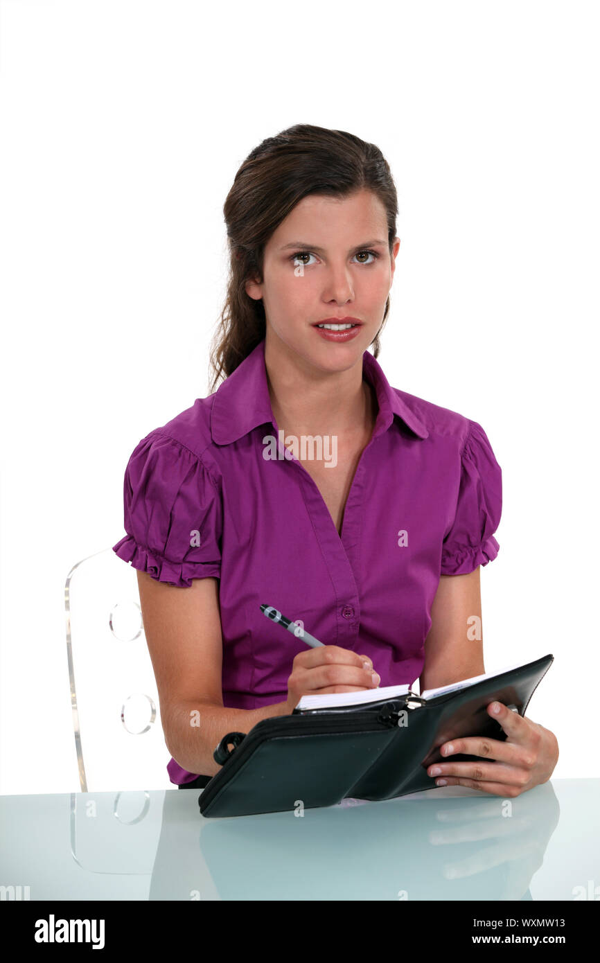 Secretary writing in diary Stock Photo - Alamy