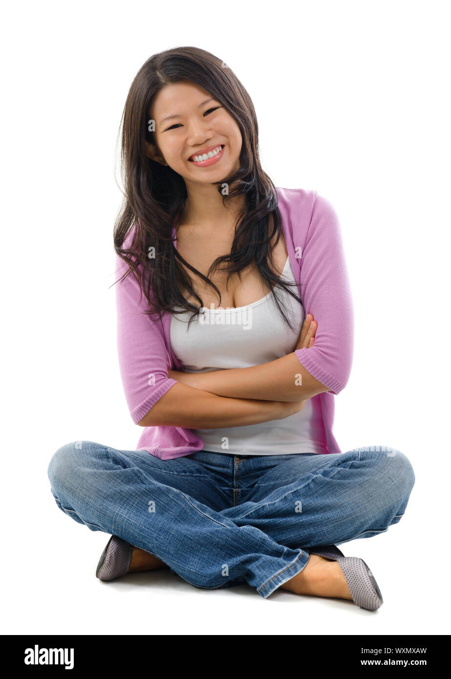 Portrait of cheerful Asian woman sitting isolated over white background ...