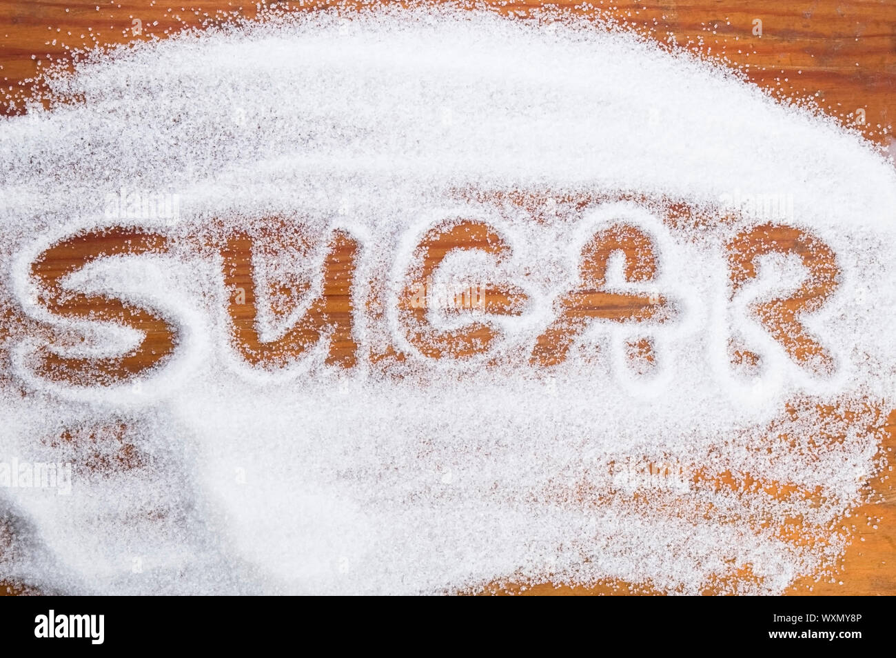 The word sugar written into a pile of white granulated sugar Stock ...
