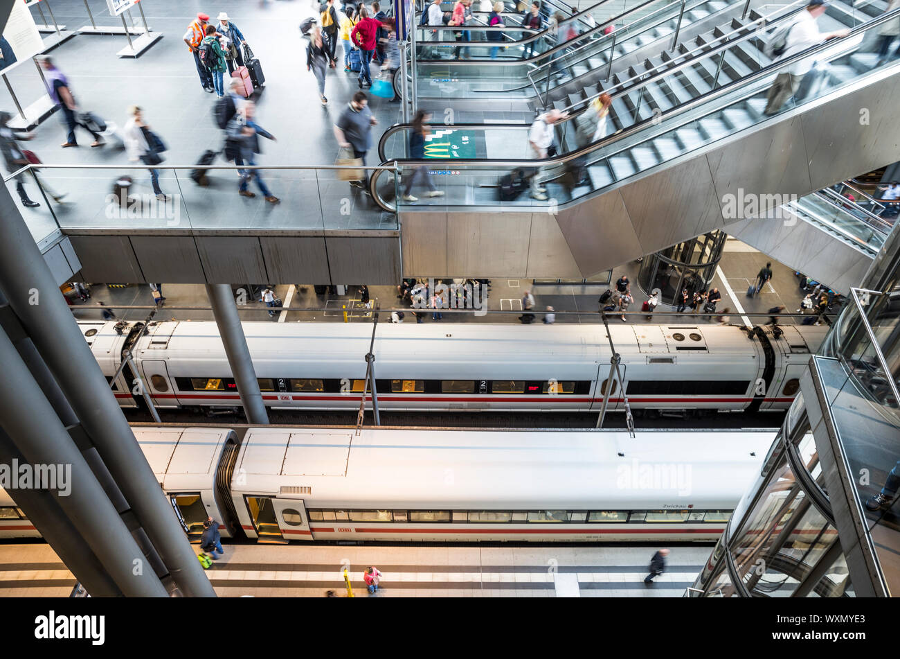 Passengers, and a train waiting at a platform inside the main train ...