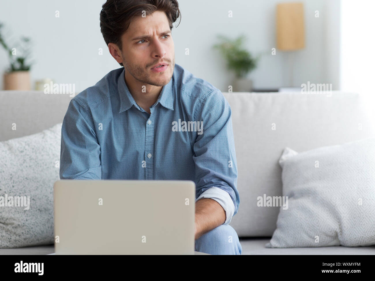 Pensive Entrepreneur At Laptop Thinking Sitting On Couch Stock Photo ...