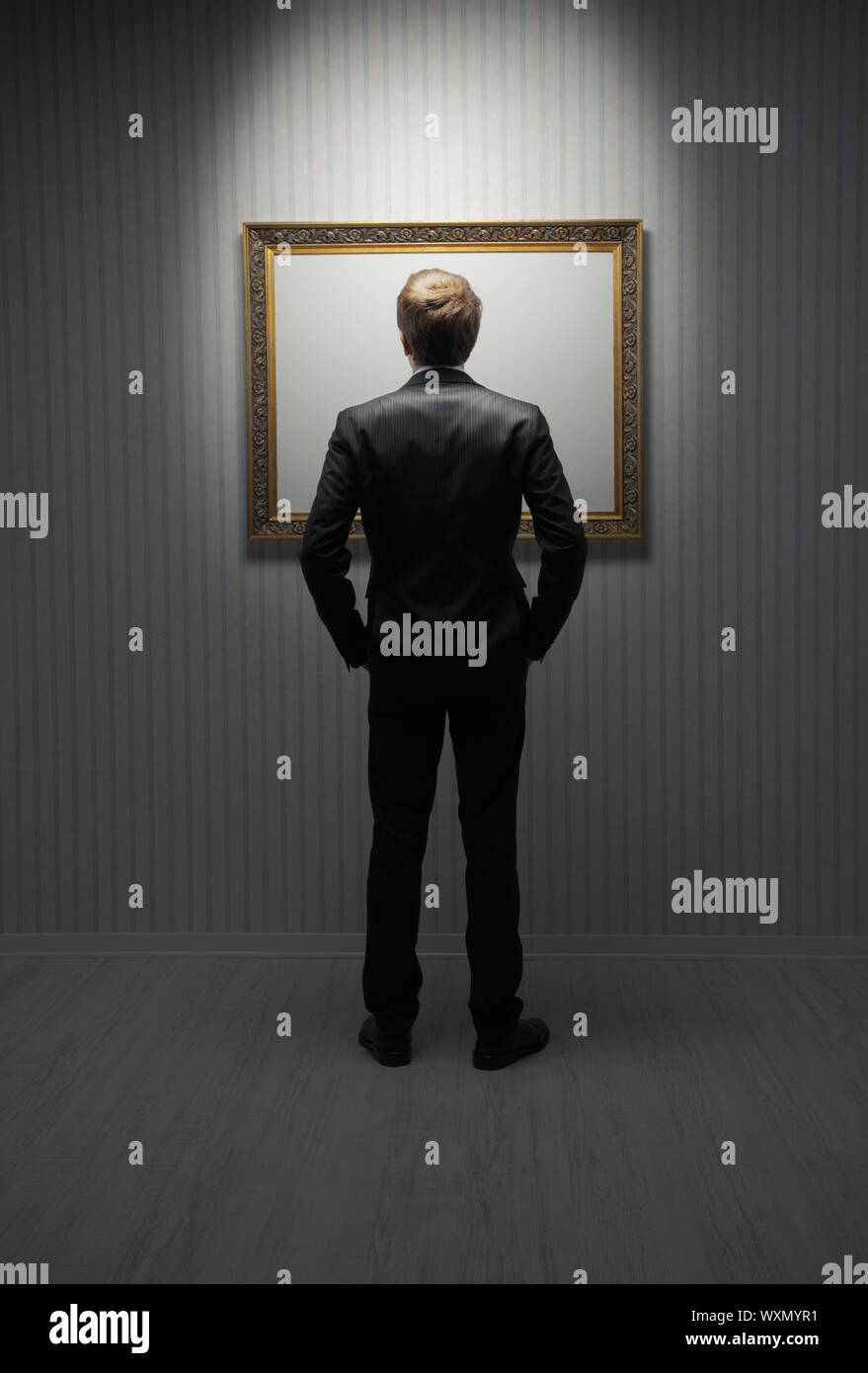 A young man standing in front a empty frame in a museum Stock Photo - Alamy