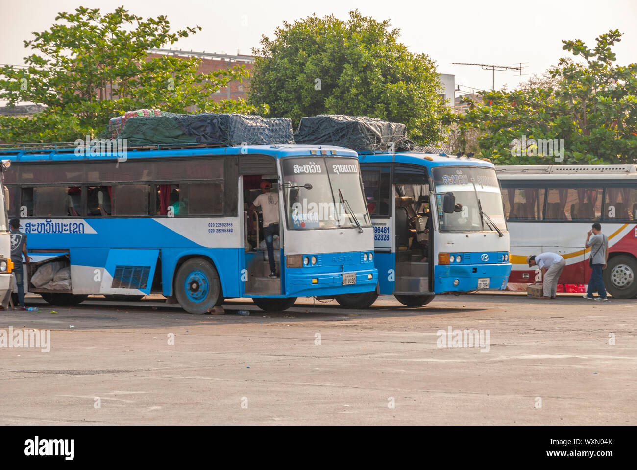 Nakasong, Laos - Mar 2016: Local bus station with long distance busses ...