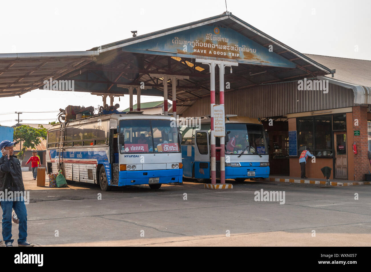 Nakasong, Laos - Mar 2016: Local bus station with long distance busses ...