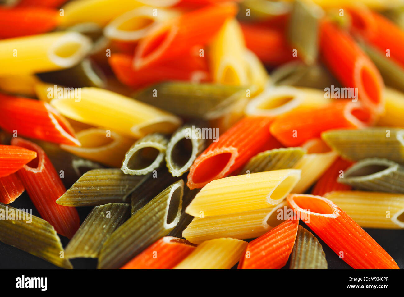 Colored dry italian pasta background Stock Photo - Alamy