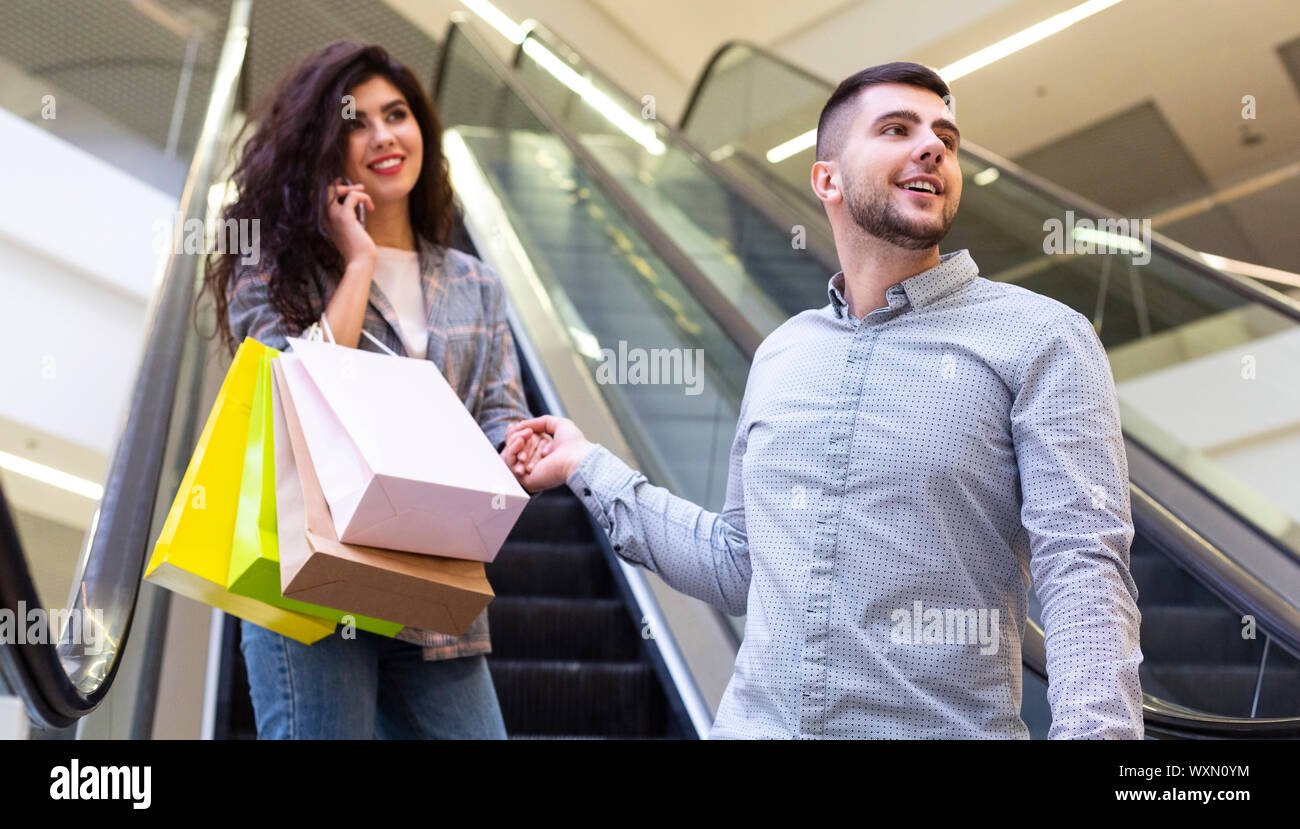 Happy couple spending time in shopping mall Stock Photo - Alamy