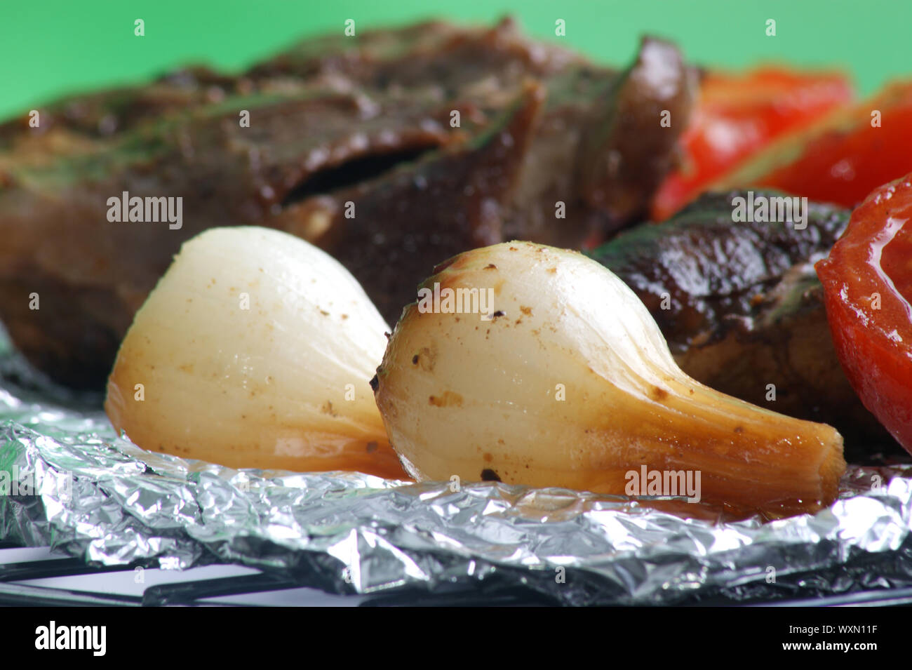 organic meat and onion on a grill Stock Photo - Alamy