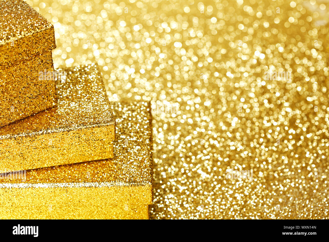 Golden boxes with holiday gifts on shiny glitter background Stock Photo ...