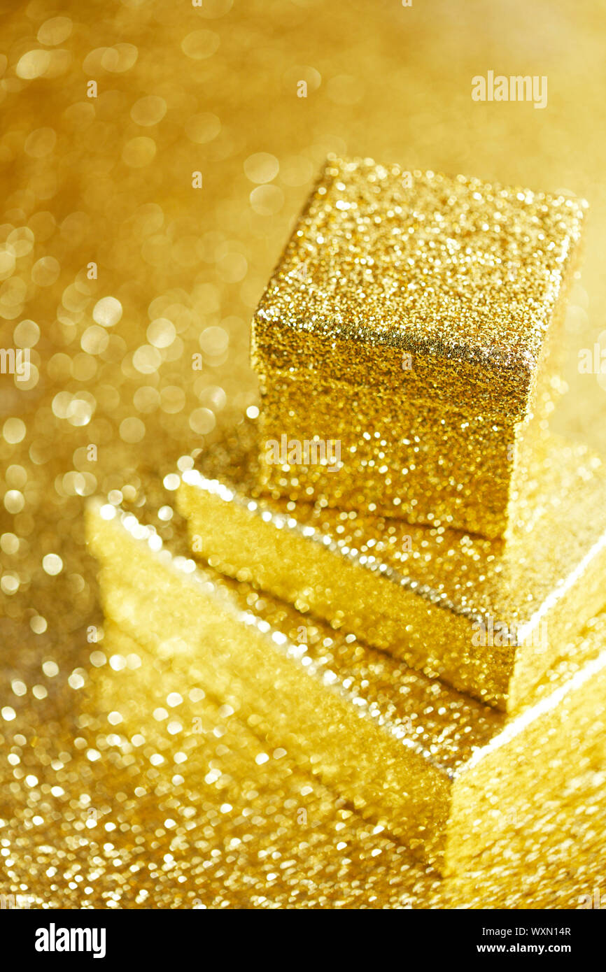 Golden boxes with holiday gifts on shiny glitter background Stock Photo ...