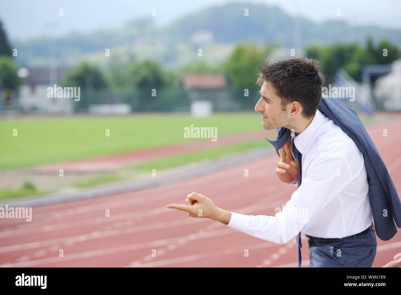 Football coach giving instructions to his team Stock Photo - Alamy